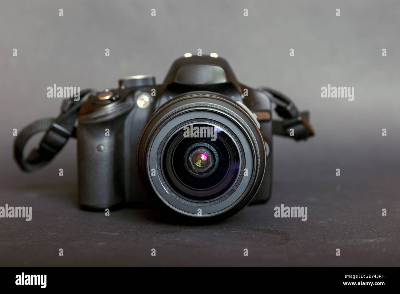 Professional modern DSLR camera low key image. Modern camera with a ...