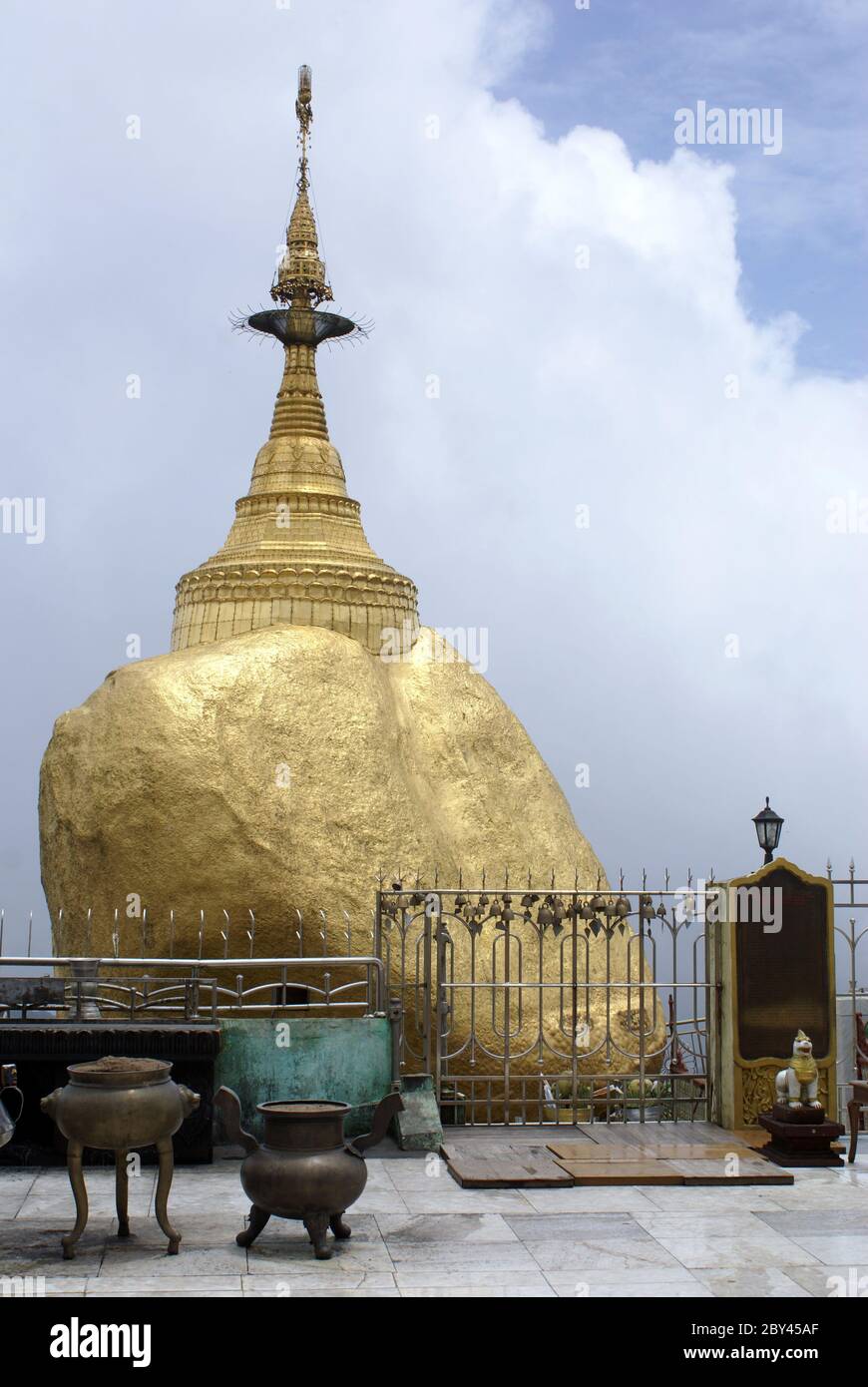 Golden rock and shrine Stock Photo - Alamy