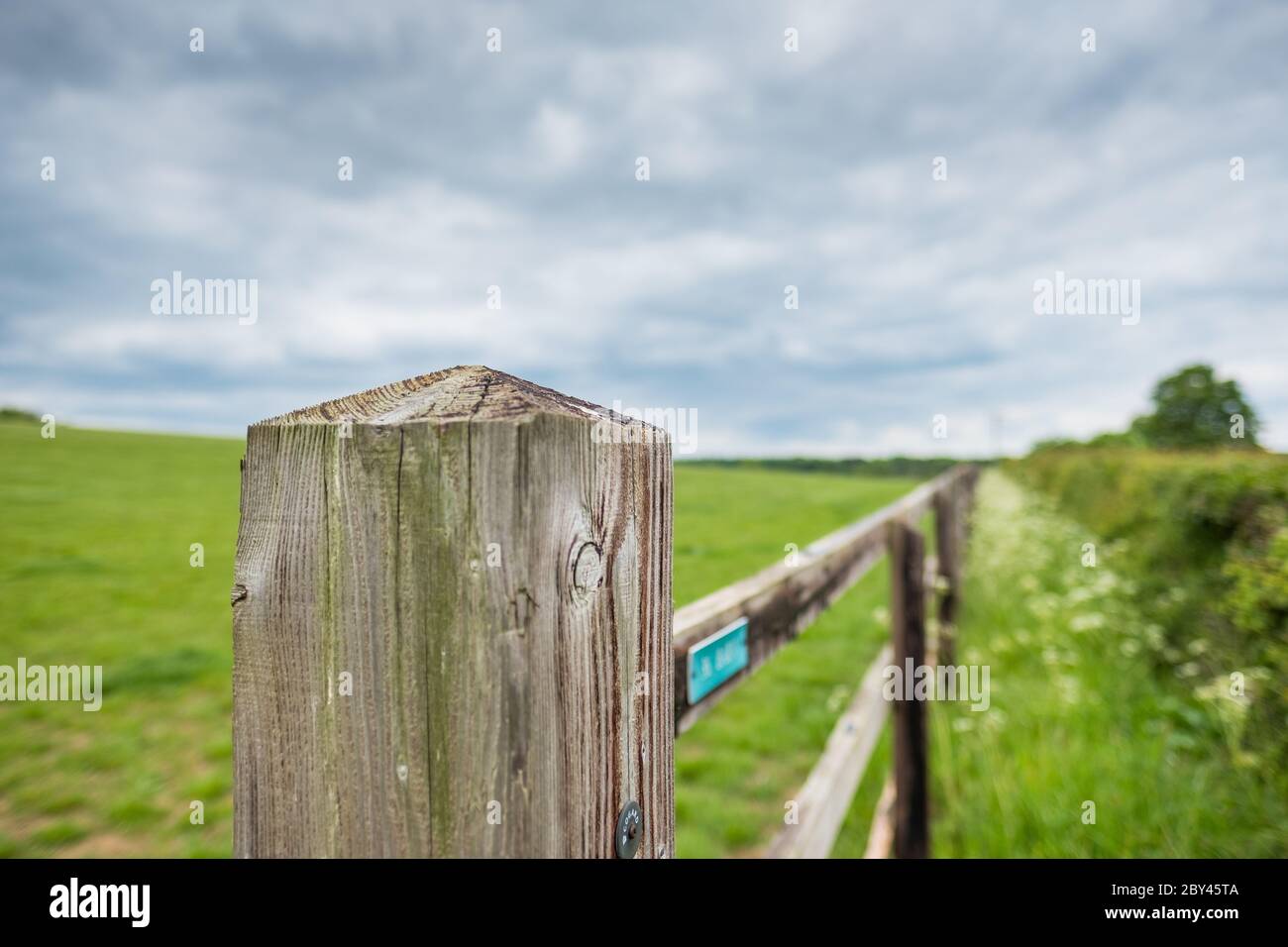 Detailed view of a farm wooden post, seen at the entrance to a large ...