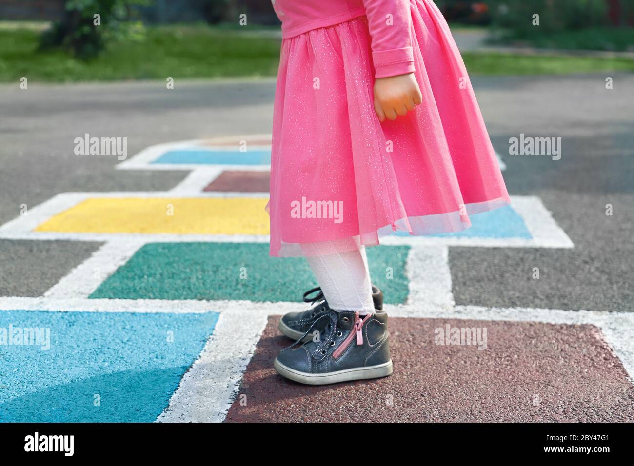 Young cute girl playing hopscotch on backyard Stock Photo - Alamy