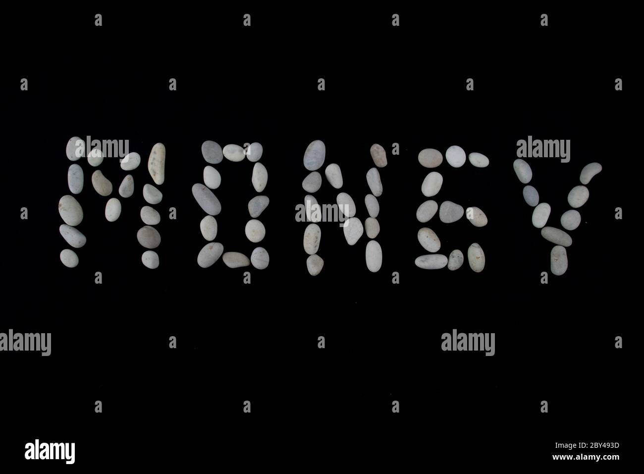 Money text on black color background with copy space using with stones ...