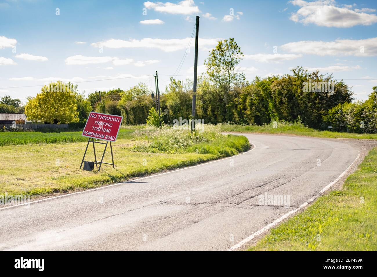 Ground level view of an empty rural road showing the textured road ...