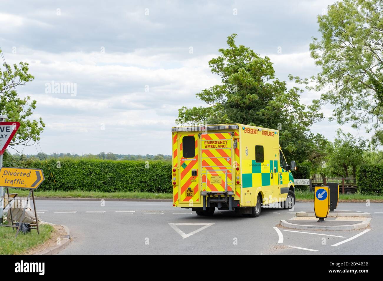 Emergency ambulance seen following a Diversion Sign at a urban road ...
