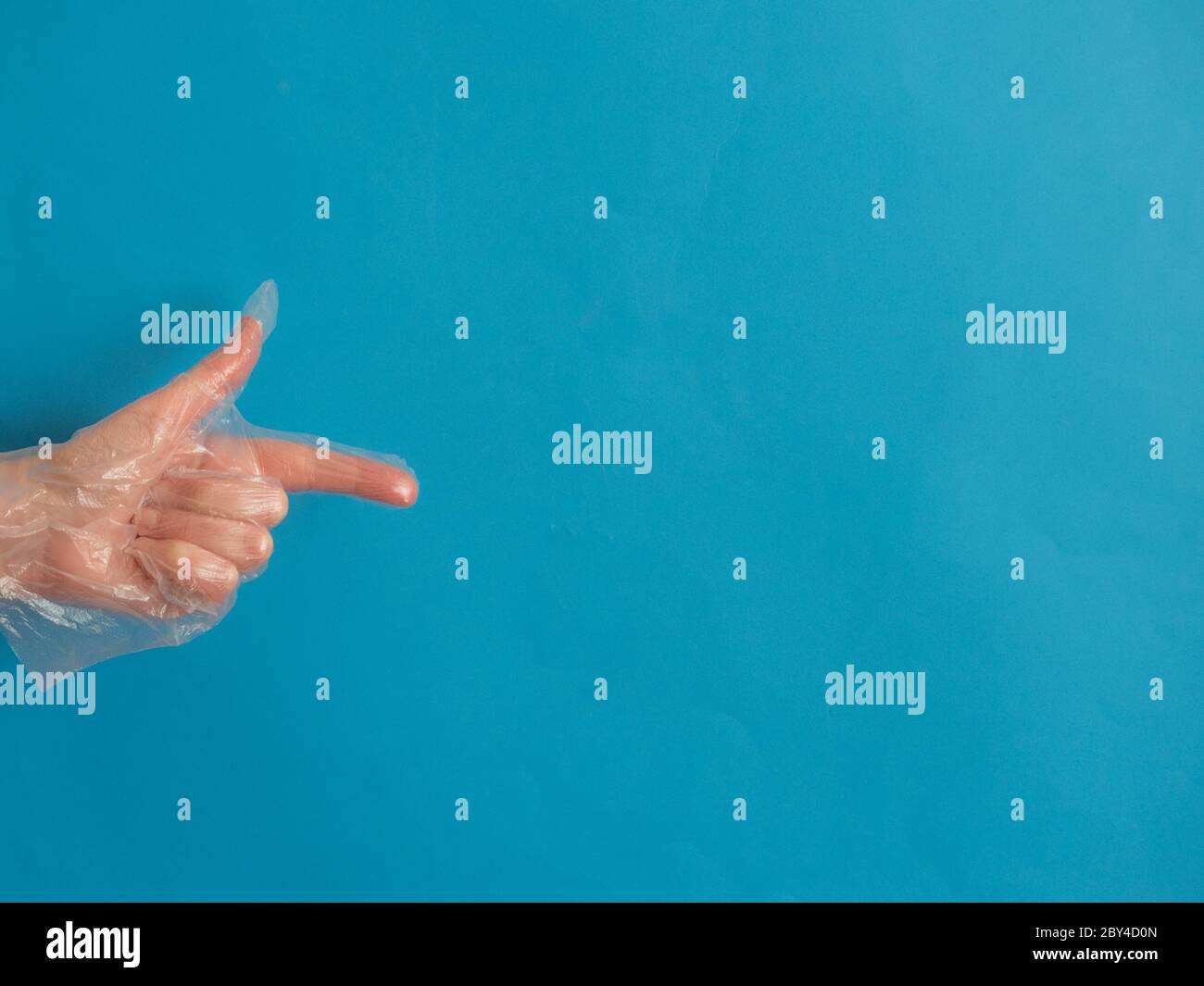 Hand with plastic glove on blue background with copy space Stock Photo ...