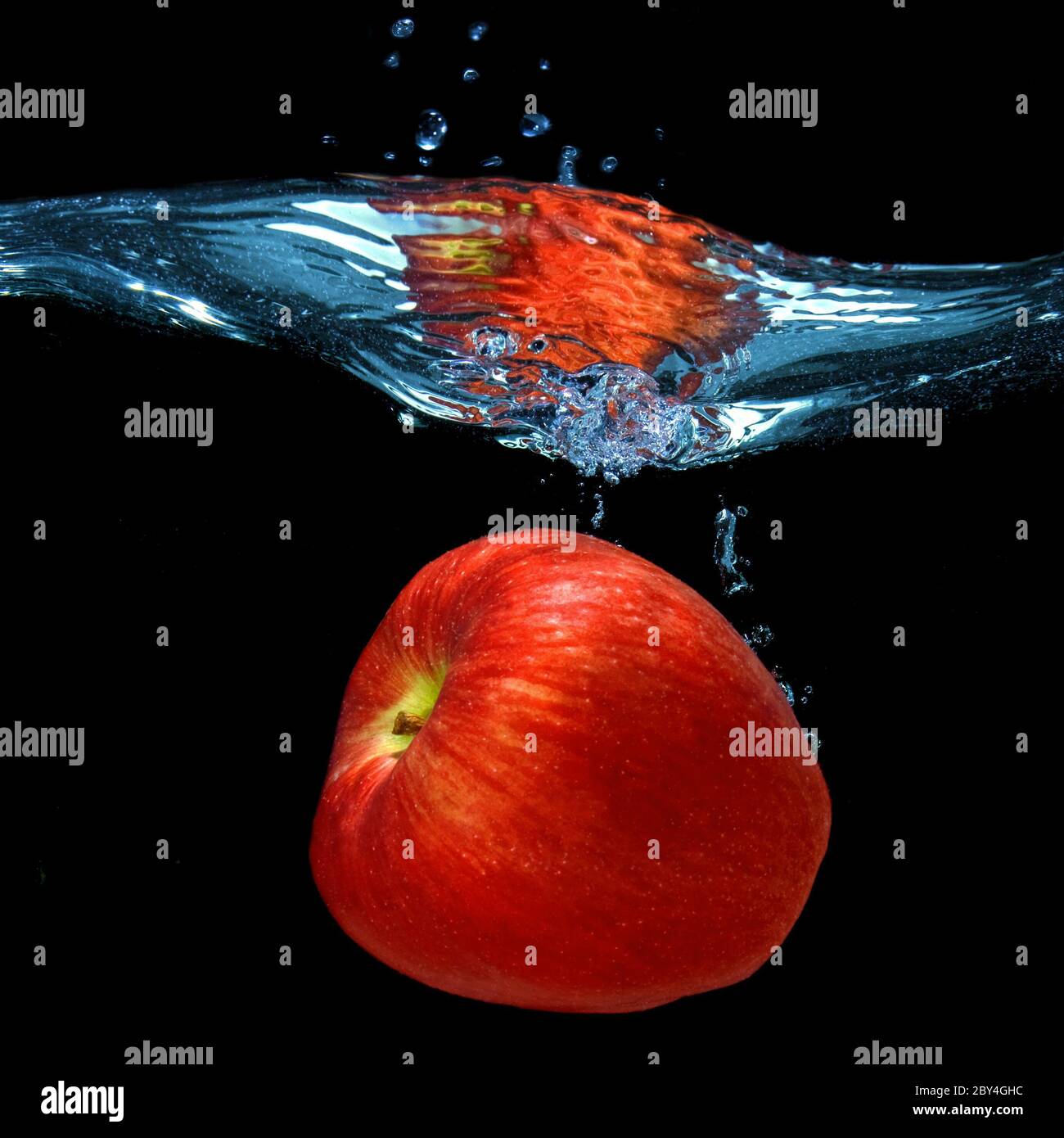 red apple dropped into water with splash isolated on black Stock Photo ...