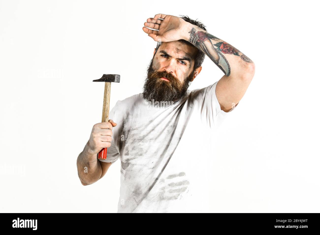 Man with tired face wipes forehead. Hard work concept. Builder ...