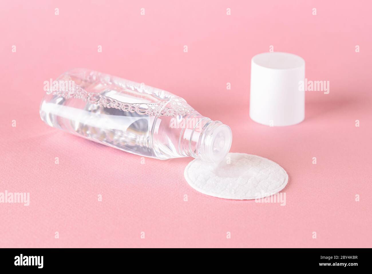 Skin tonic lotion or micellar water dripping from open bottle onto a ...