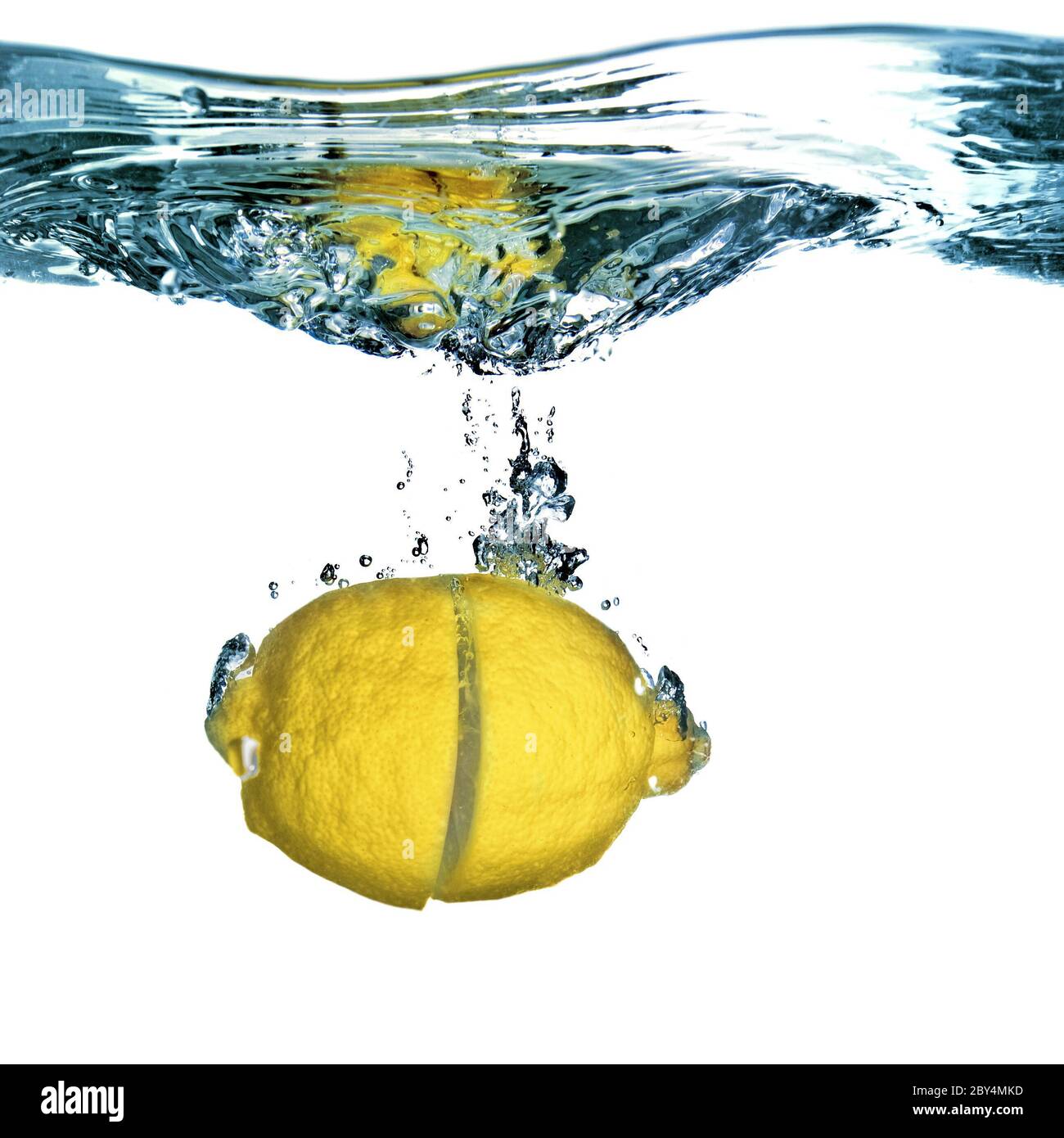 Fresh lemon dropped into water with bubbles isolated on white Stock ...