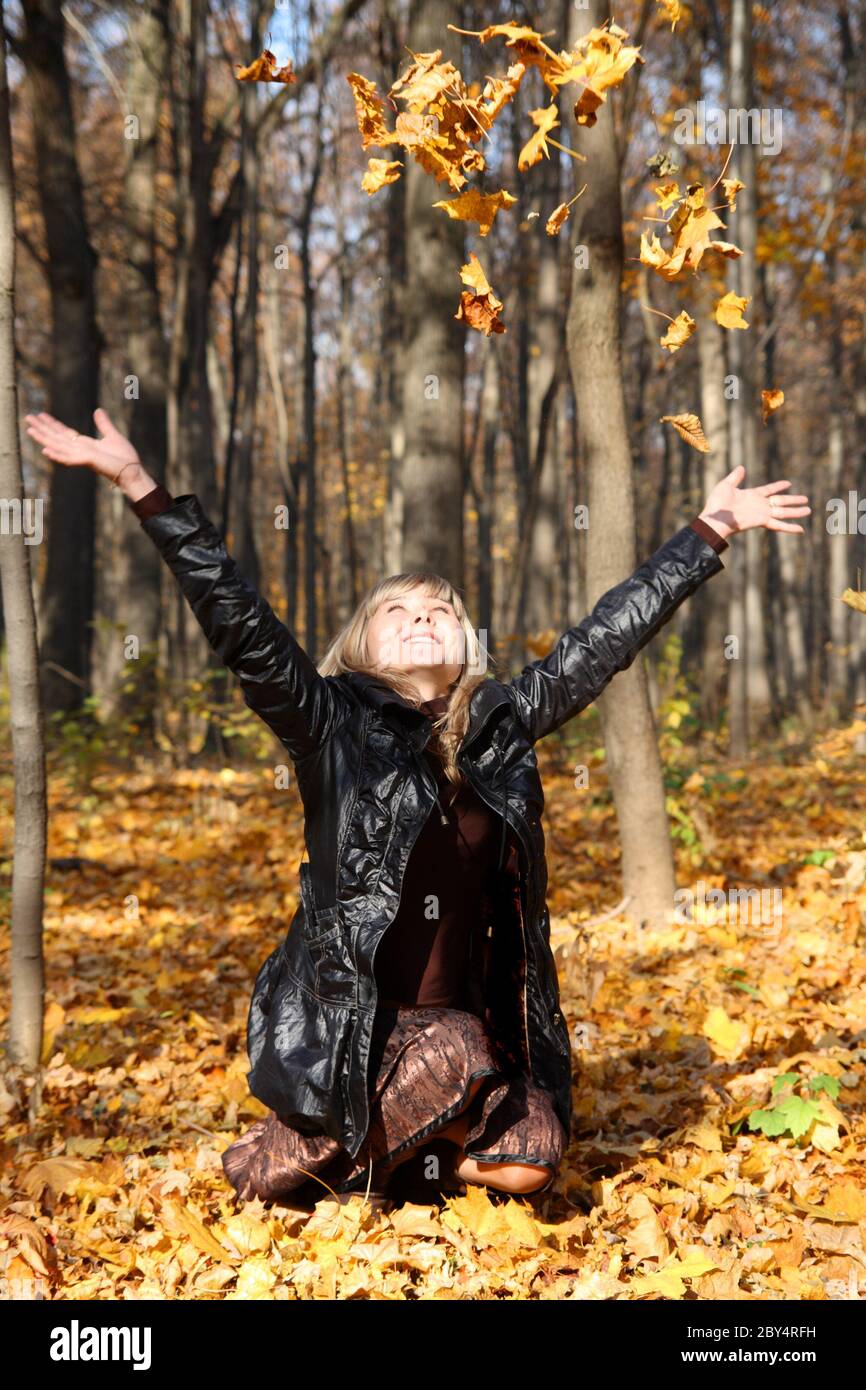 beautiful girl throwing up autumn leaves Stock Photo - Alamy