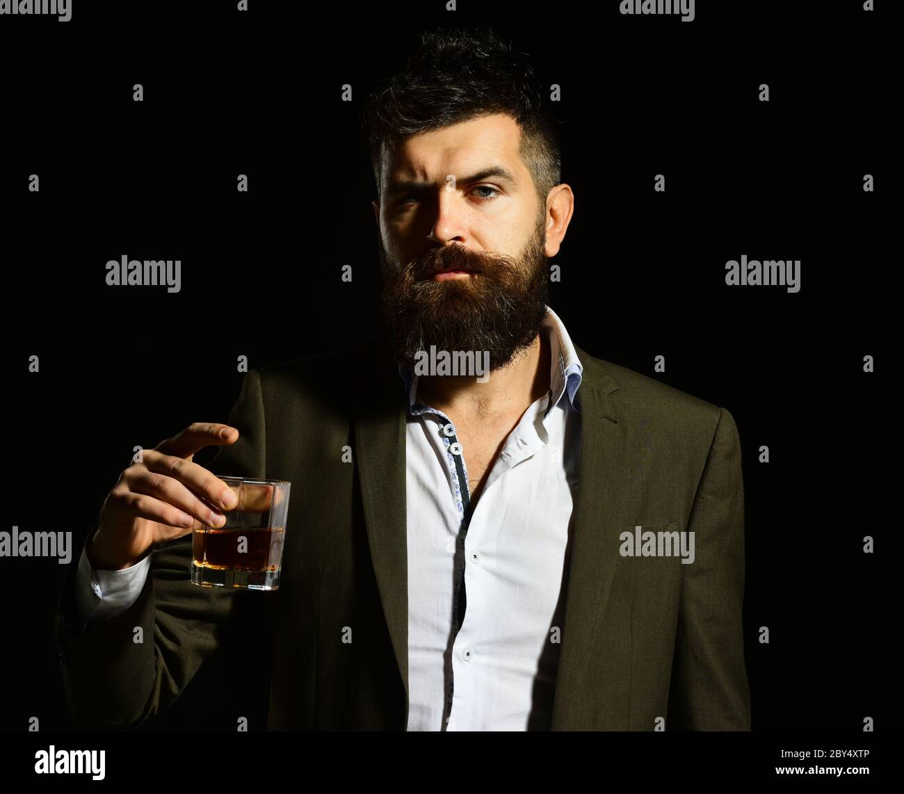 Connoisseur with elegant look drinks cognac or brandy. Man with ...