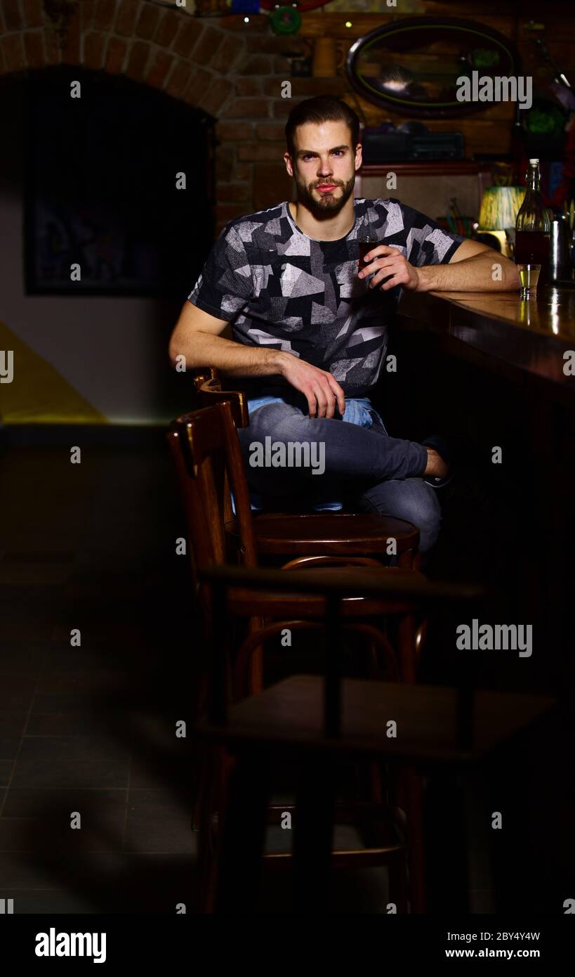 Macho in bar drinks shot and liqueur. Party concept. Man with beard ...