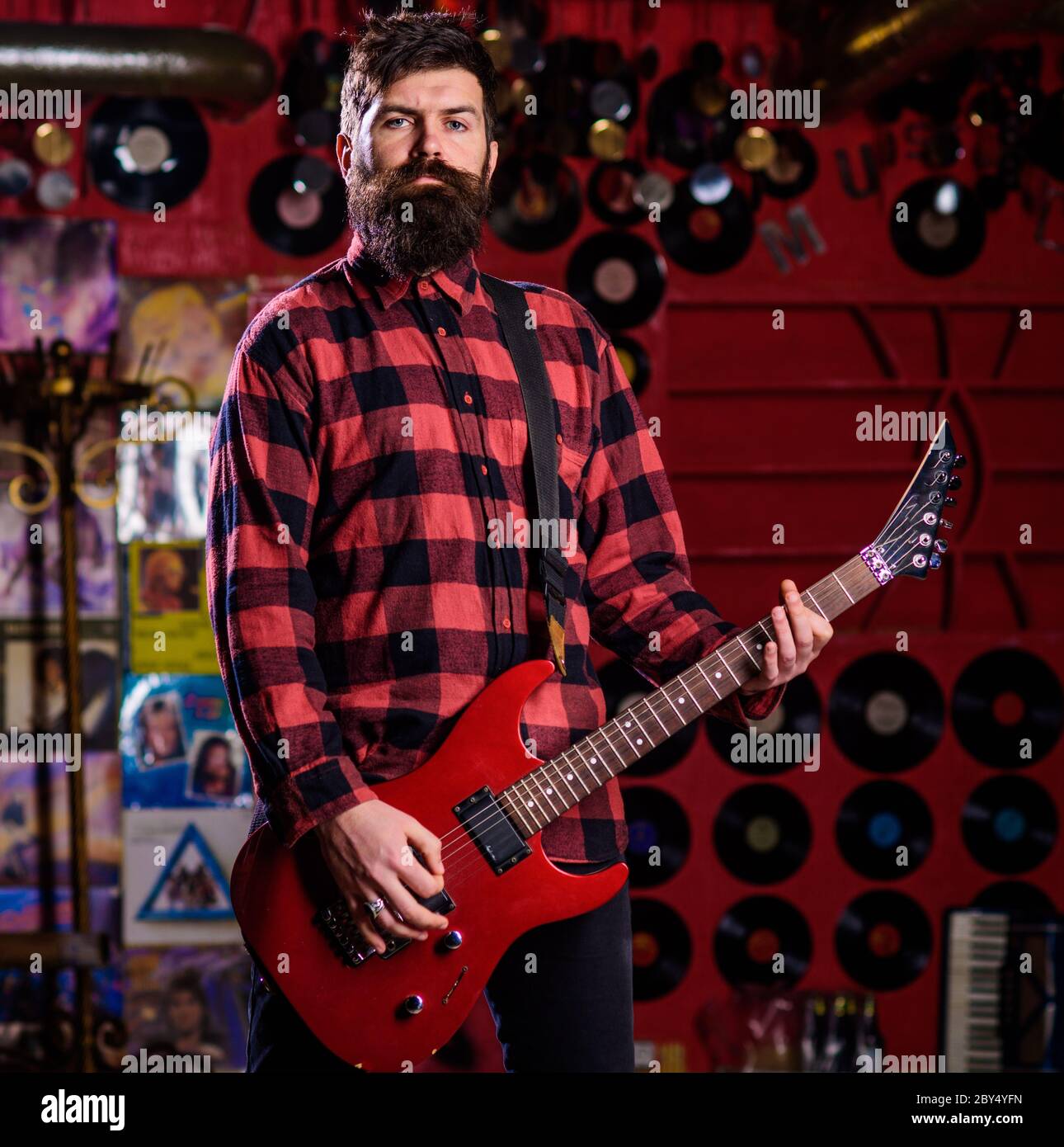 Frontman concept. Musician with beard play electric guitar on stage ...