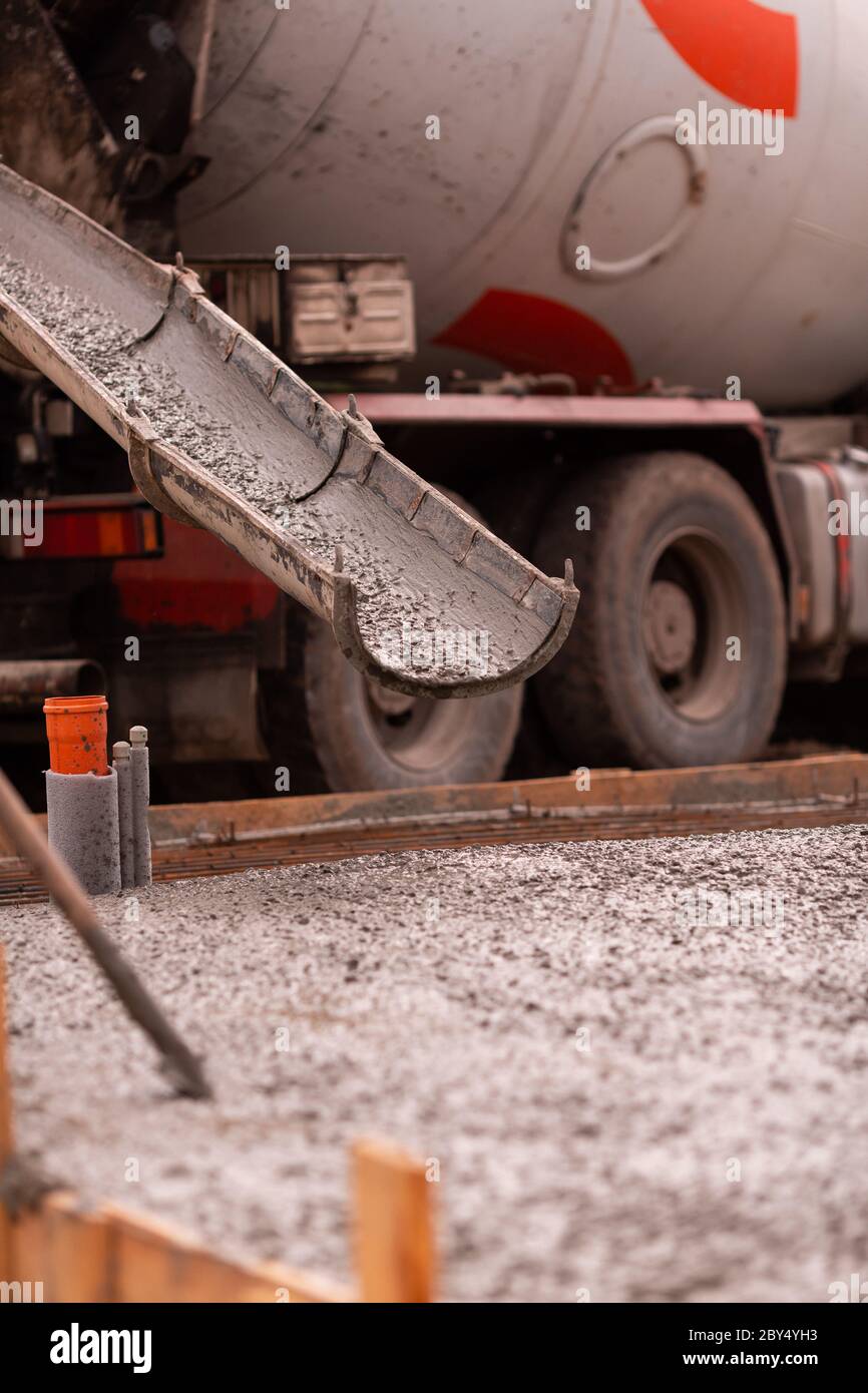 Lay of the cement or concrete into the foundation formwork from ...