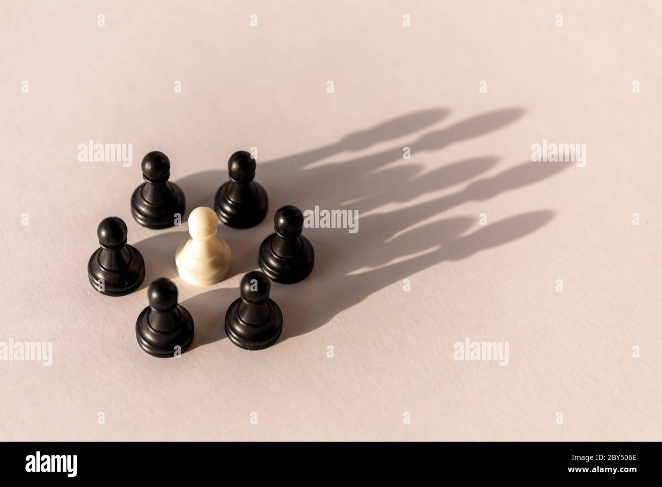 Plastic chess pawn circle with shadow shaped as crown on white ...