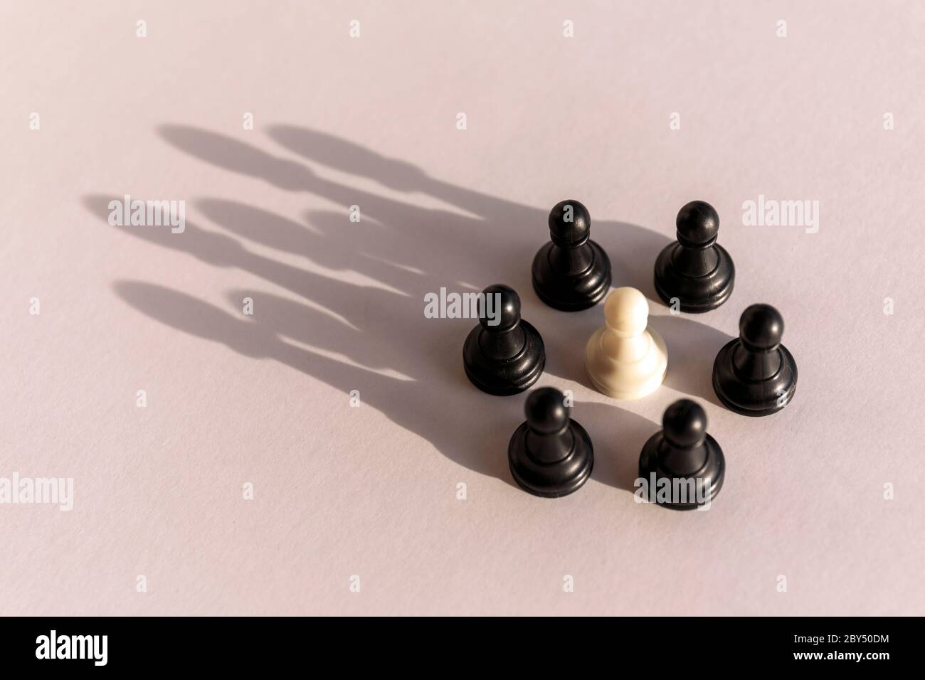 Plastic chess pawn circle with shadow shaped as crown on white ...