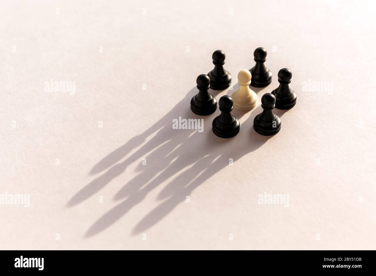 Plastic chess pawn circle with shadow shaped as crown on white ...