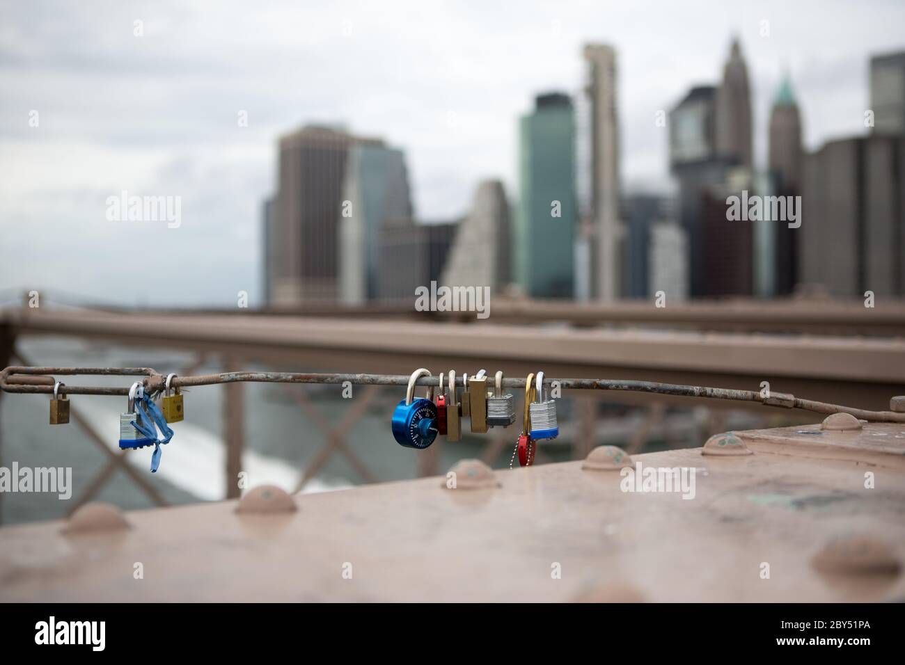 New York City buildings from Brooklyn bridge with locks on wire Stock ...