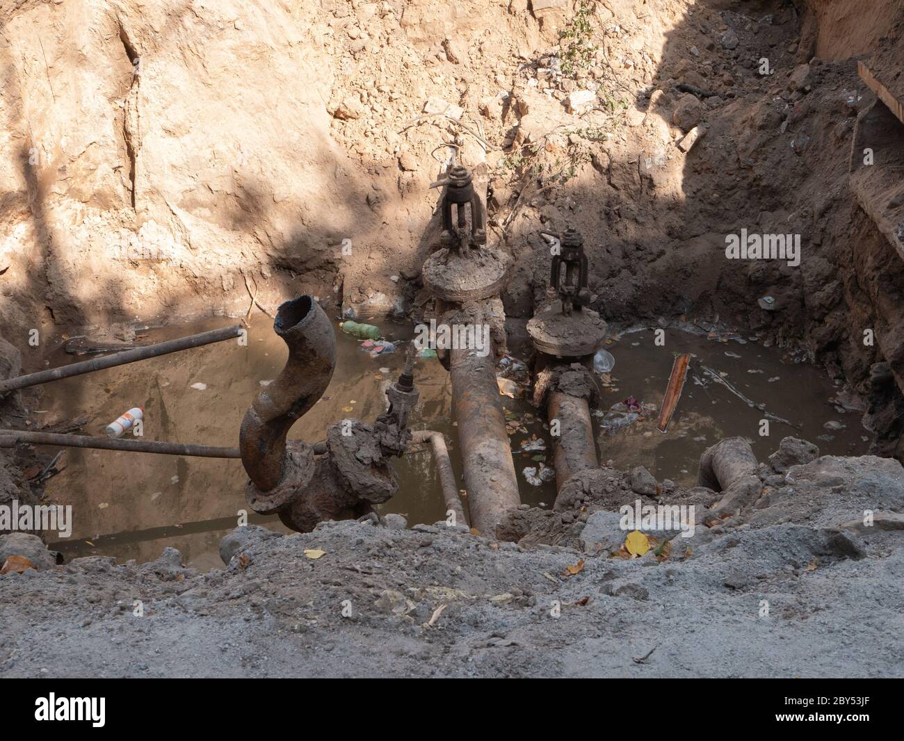 big hole in the ground with damaged pipeline sewage system after ...