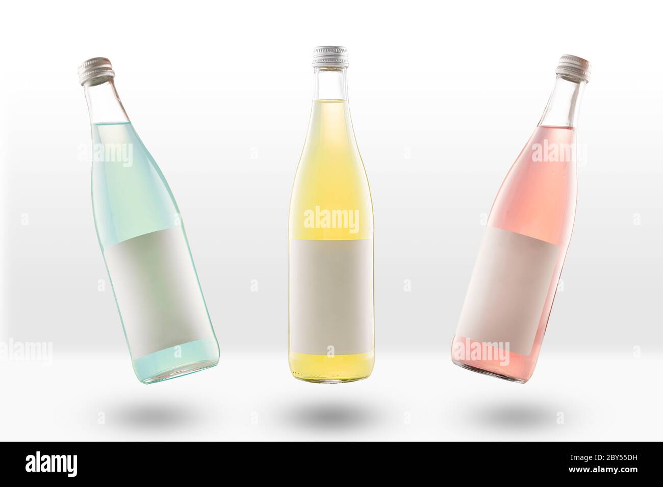 three glass bottles of lemonade and fizzy drinks, with empty mockup ...