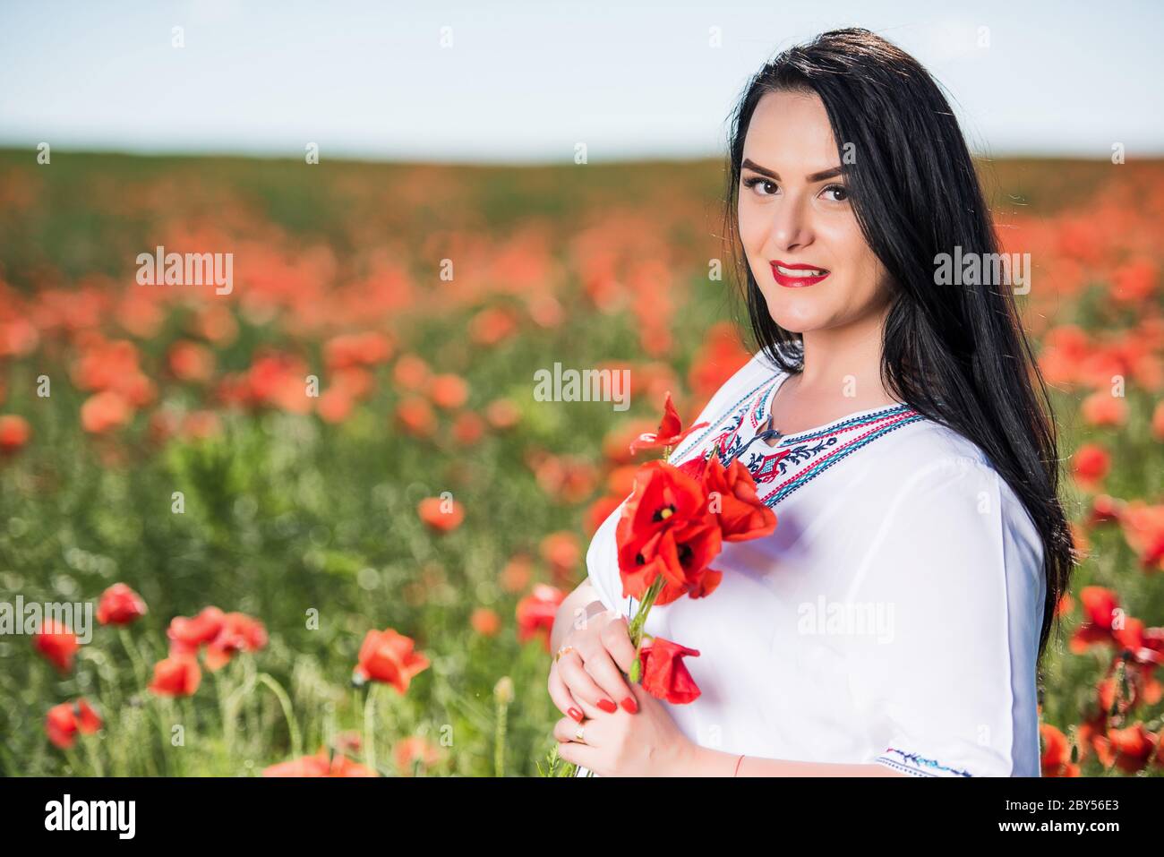 Woman in poppy field hi-res stock photography and images - Alamy