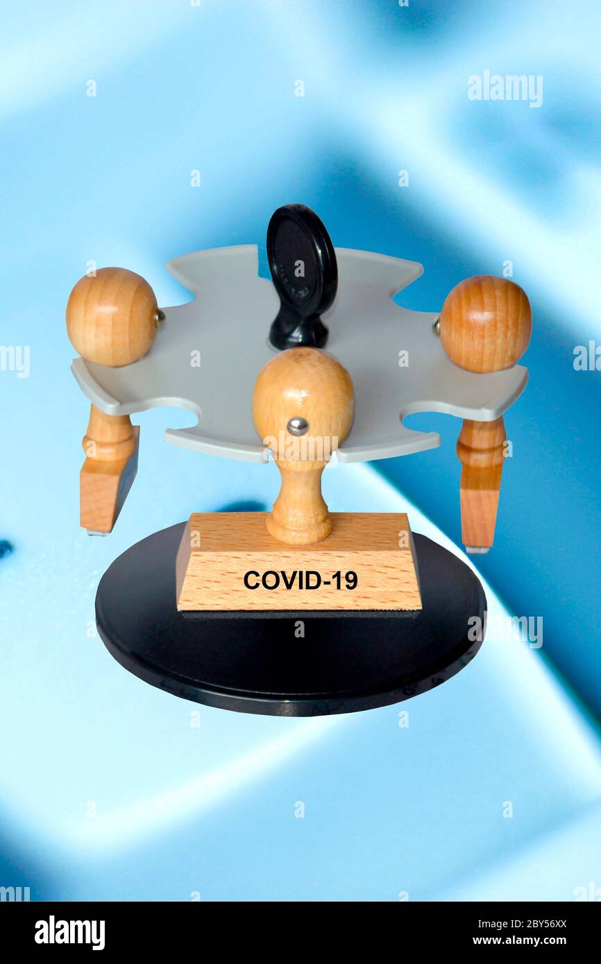 stemp at a stamp rack over a computer keyboard with the lettering Covid ...