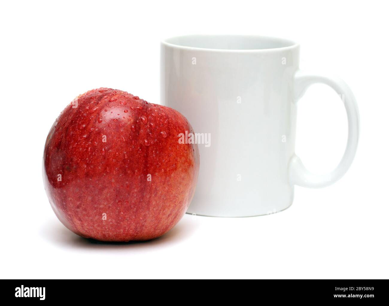 red apple and white mug Stock Photo - Alamy