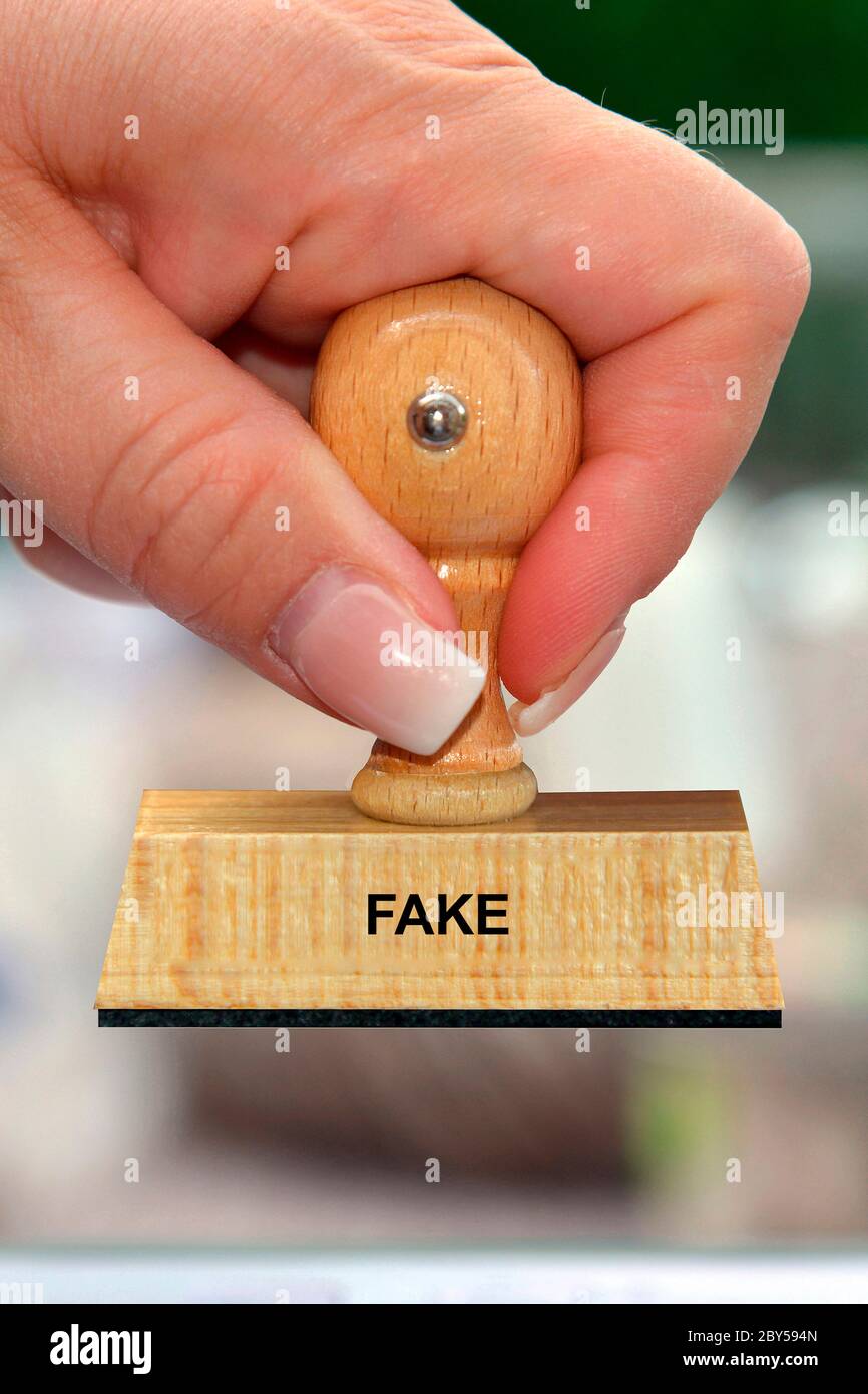 hand with stamp lettering Fake Stock Photo - Alamy