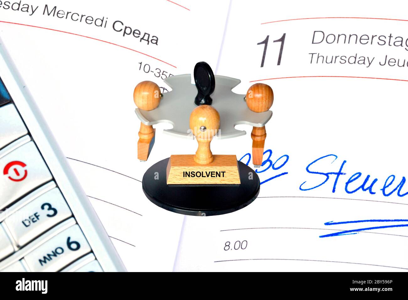 stemp at a stamp rack over a calendar sheet with the lettering ...