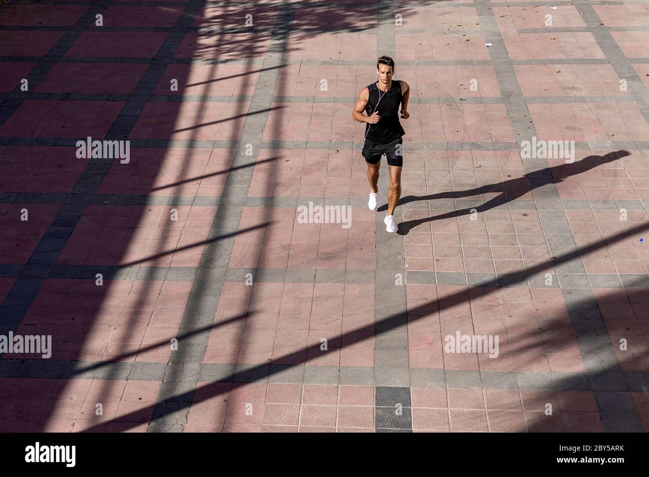 Above view athlete runner training at road in black sportswear Stock ...