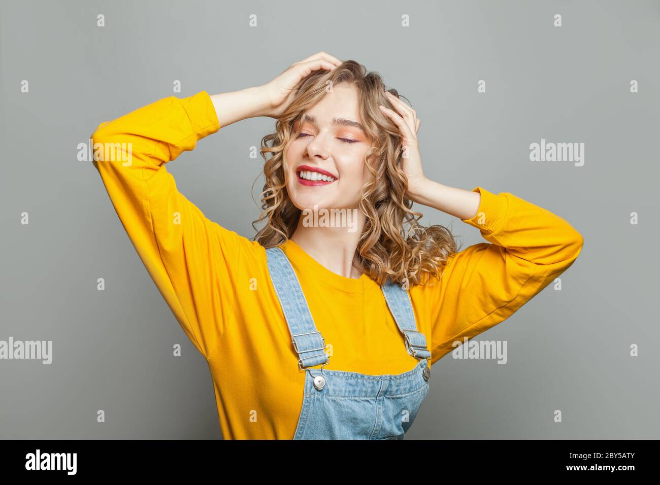 Cute model girl smiling on gray background Stock Photo - Alamy