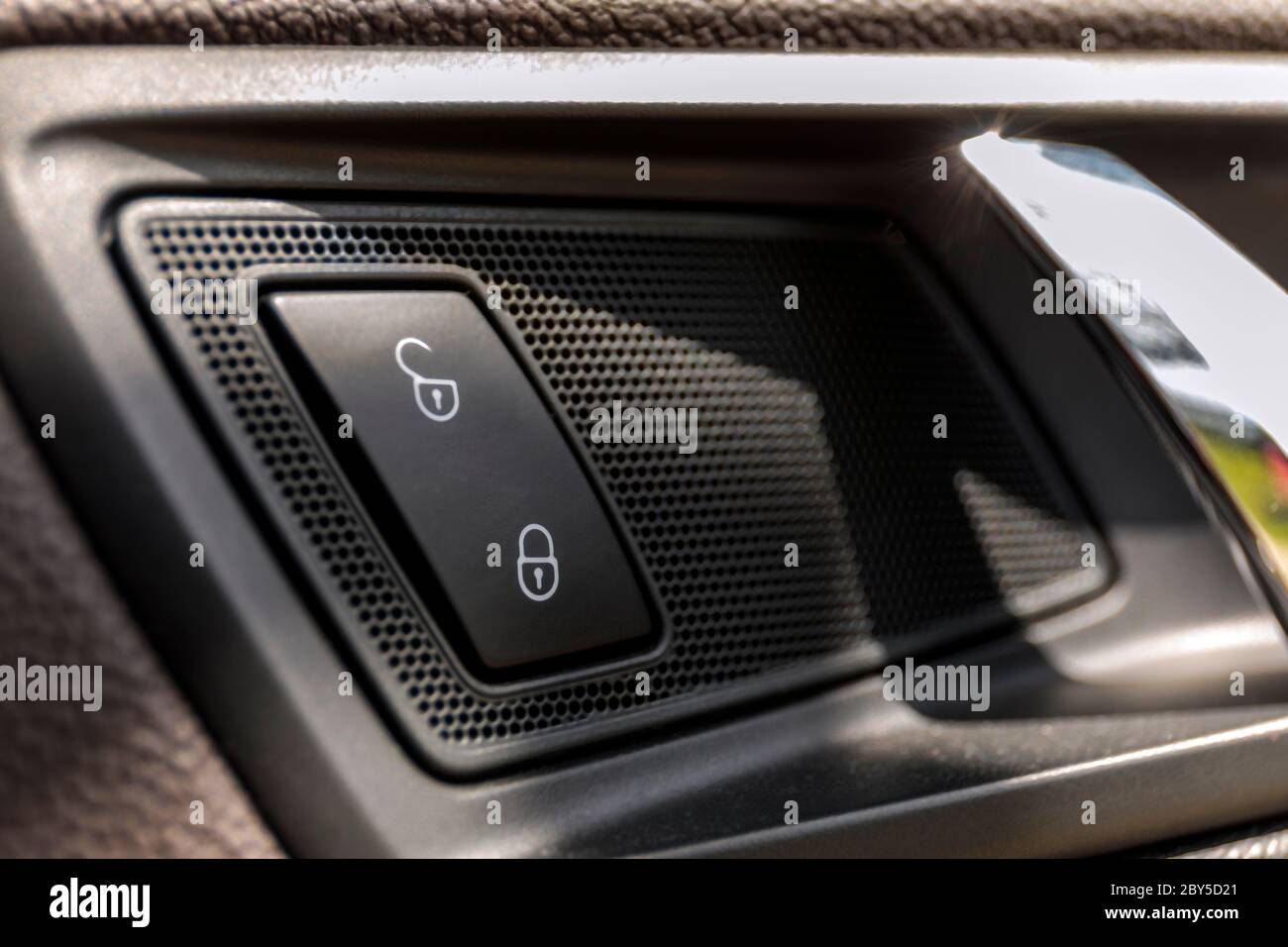 car leather interior details of door handle with windows controls and ...
