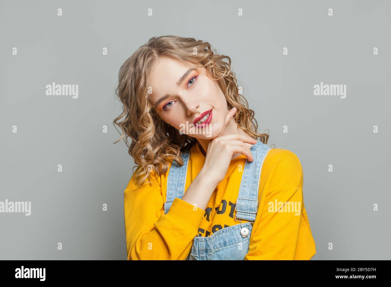 Beautiful model girl on gray background Stock Photo - Alamy