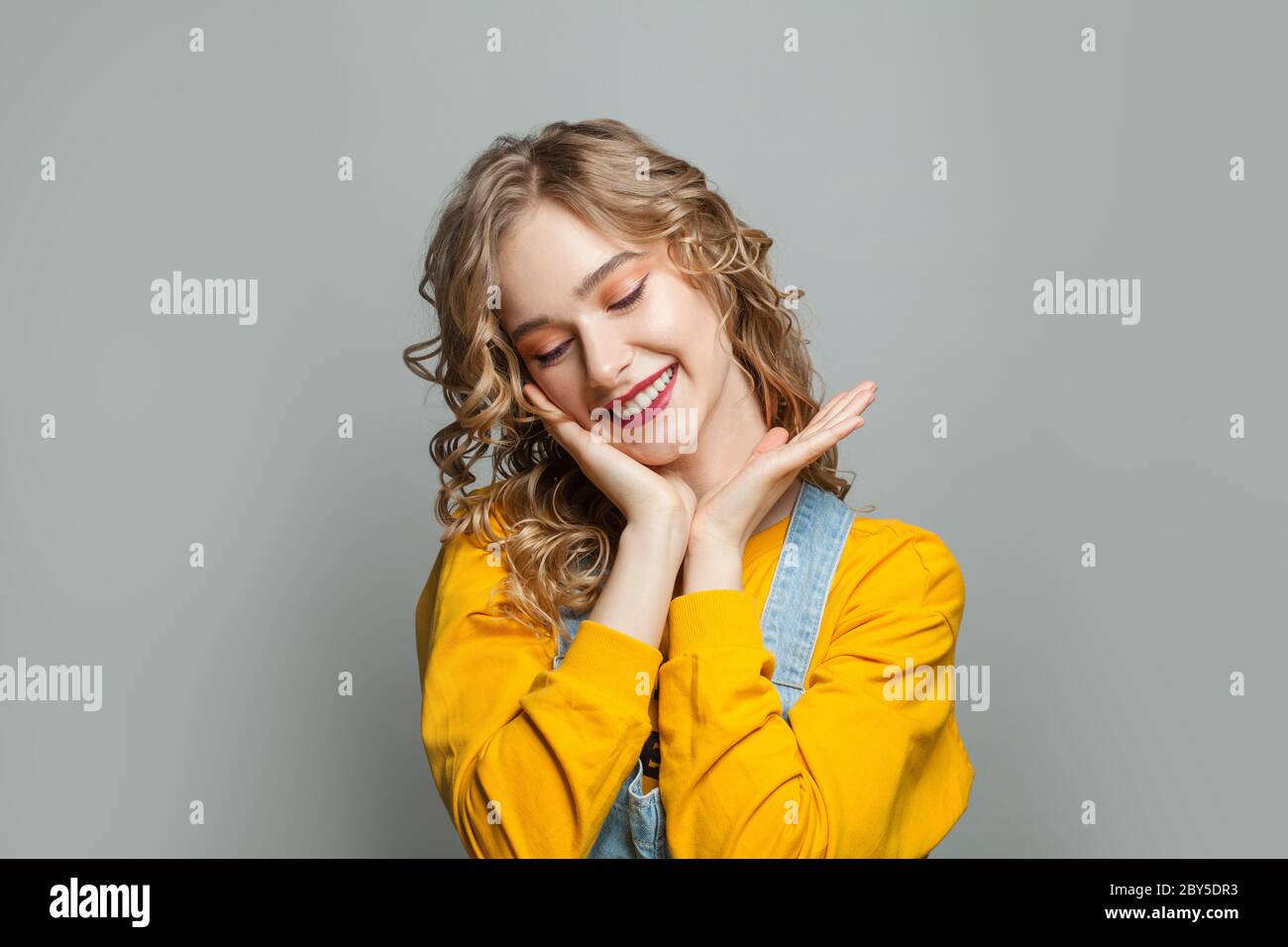 Happy model woman smiling on gray background Stock Photo - Alamy