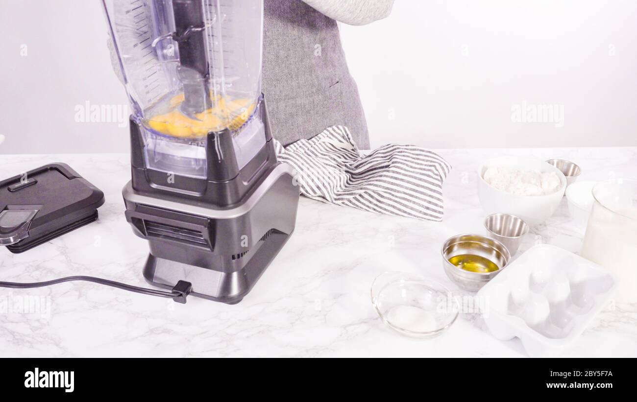 Mixing ingredient in an electric blender to make the crepes batter ...