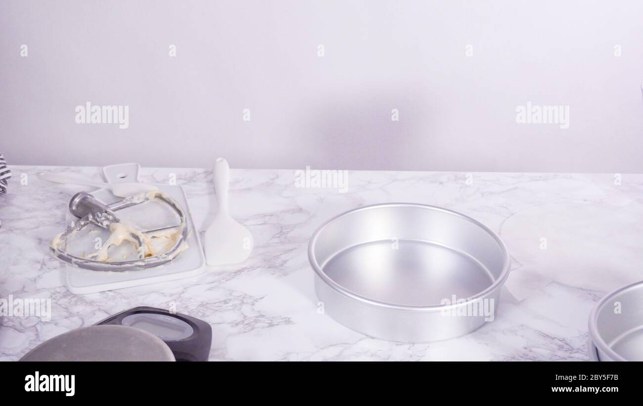 Step by step. Greasing cake pans with butter to bake funfetti cake ...