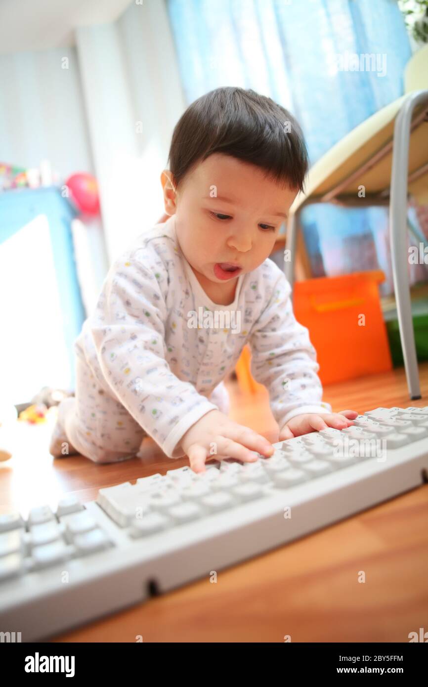 baby and computer keyboard, soft focus Stock Photo - Alamy