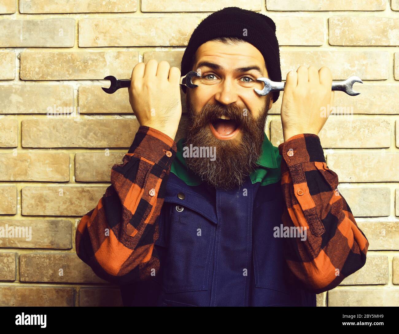 Bearded man, long beard. Brutal caucasian mechanic, smiling happy ...