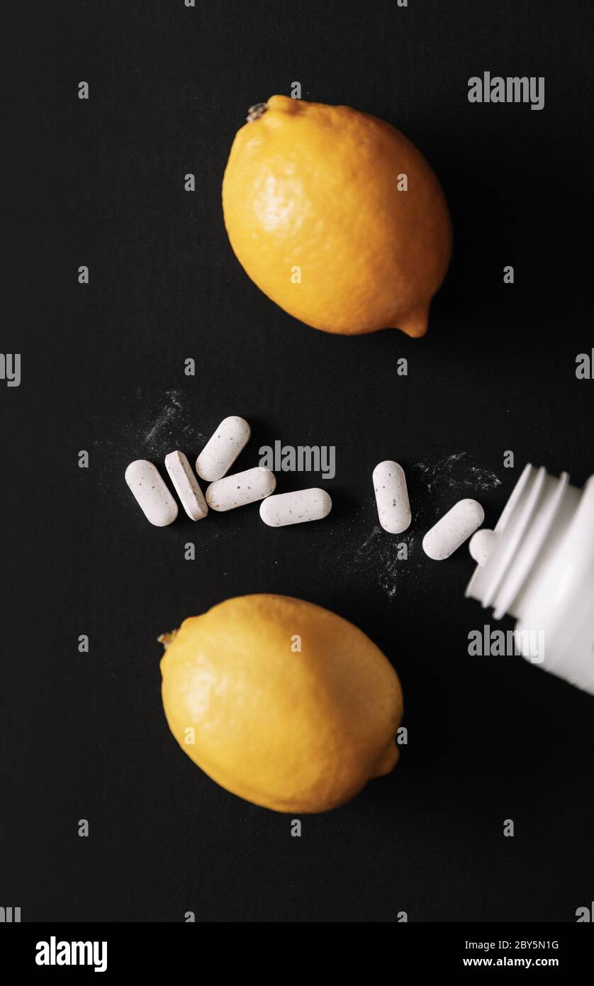 Vitamin C capsules. Pills with pill bottle and bio lemon fruit isolated ...