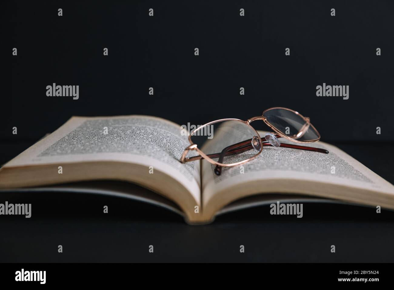 open book with glasses Stock Photo - Alamy