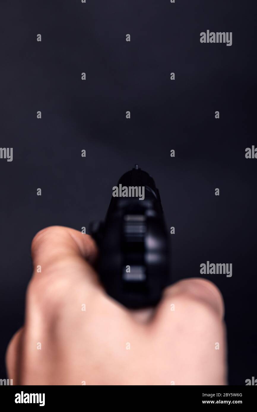 Male hand with gun isolated on black background. Man with a gun ready ...