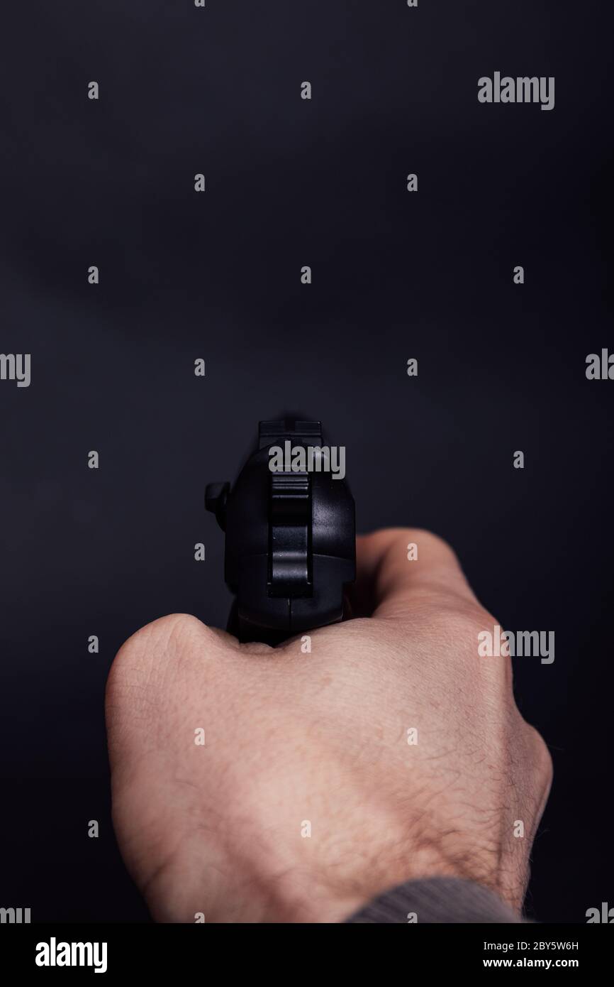 Male hand with gun isolated on black background. Man with a gun ready ...