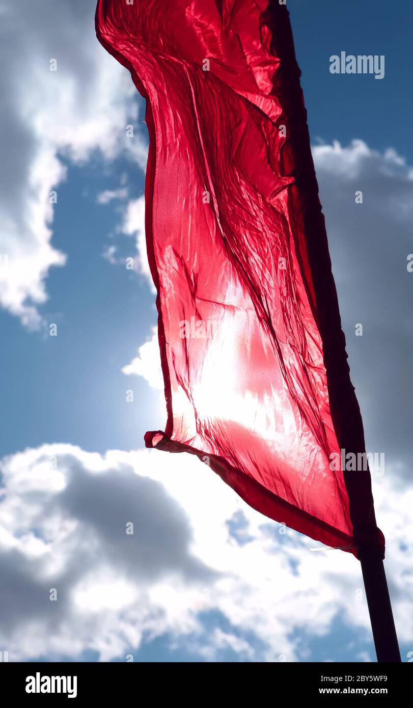 brightly red flag Stock Photo - Alamy