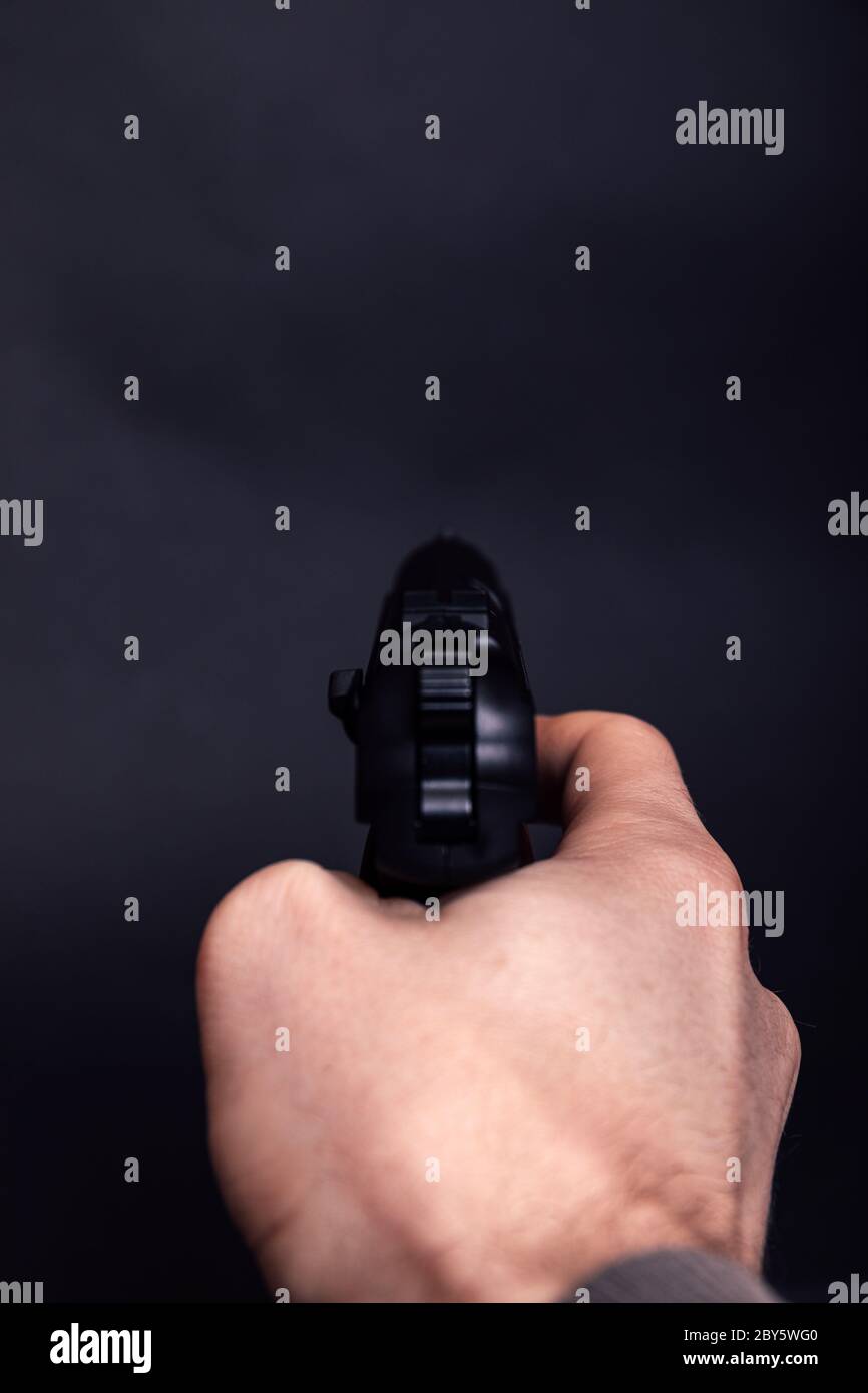 Male hand with gun isolated on black background. Man with a gun ready ...