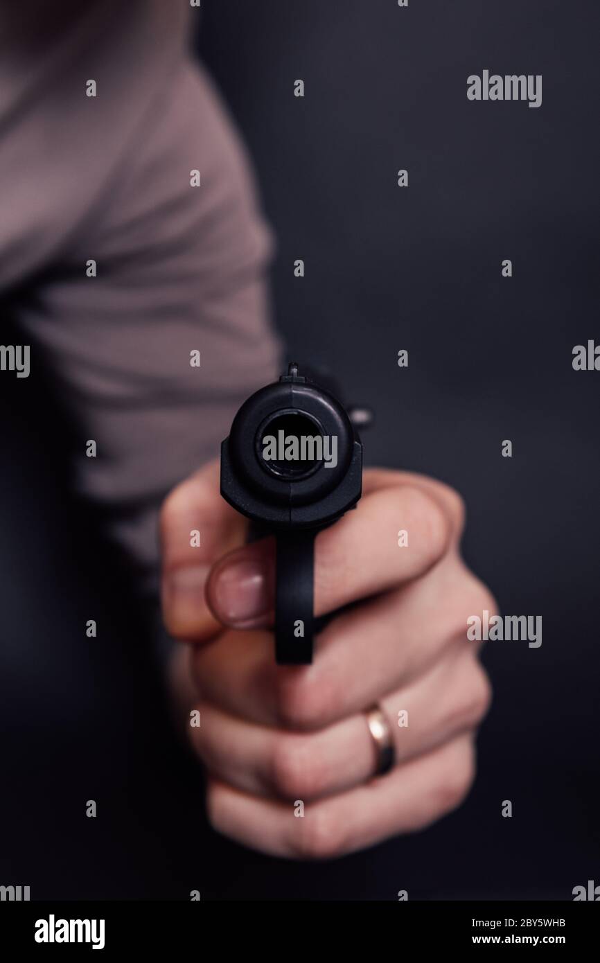 Male hand with gun isolated on black background. Man with a gun ready ...