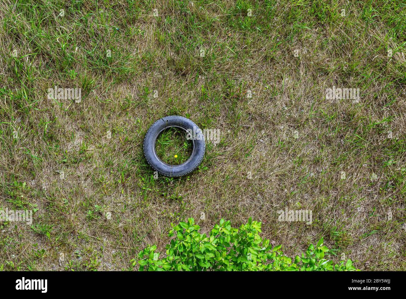 Old tire from a car wheel, photographed from above on a background of ...