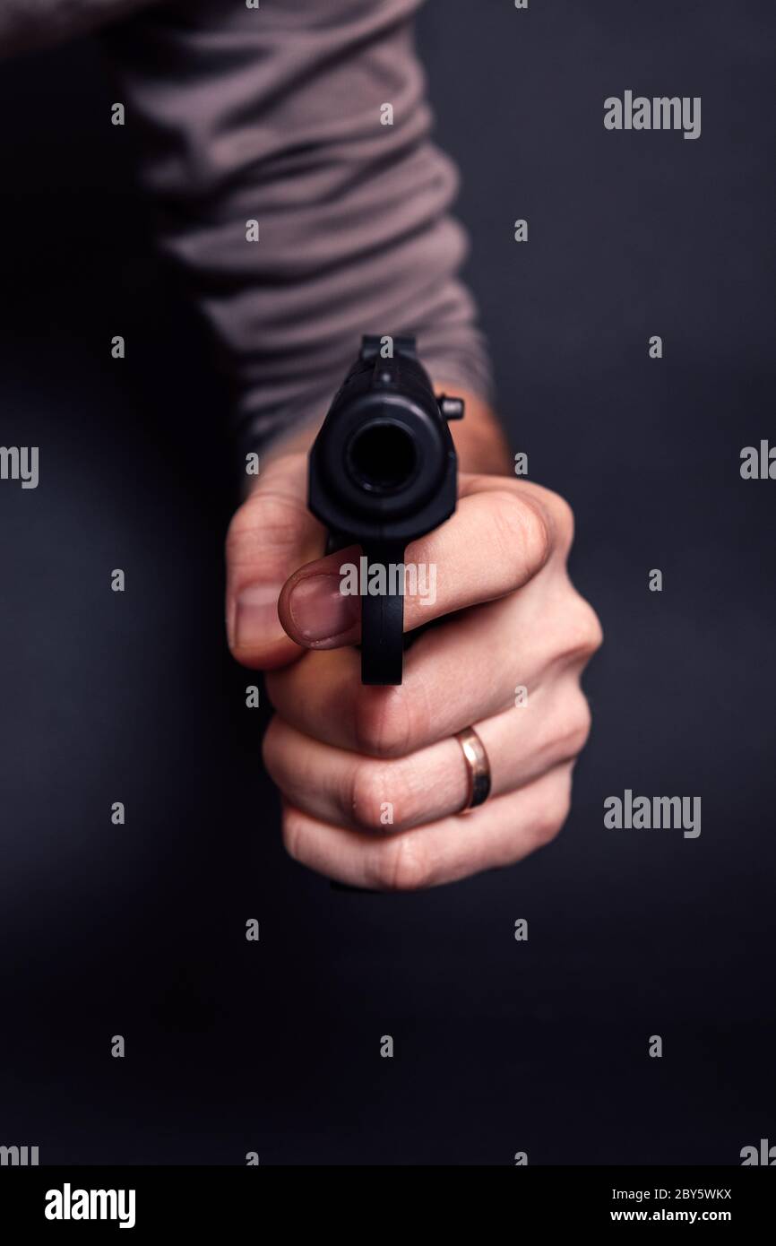 Male hand with gun isolated on black background. Man with a gun ready ...