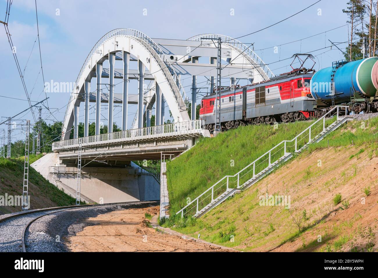 Freight train moves through the new bridge Stock Photo - Alamy