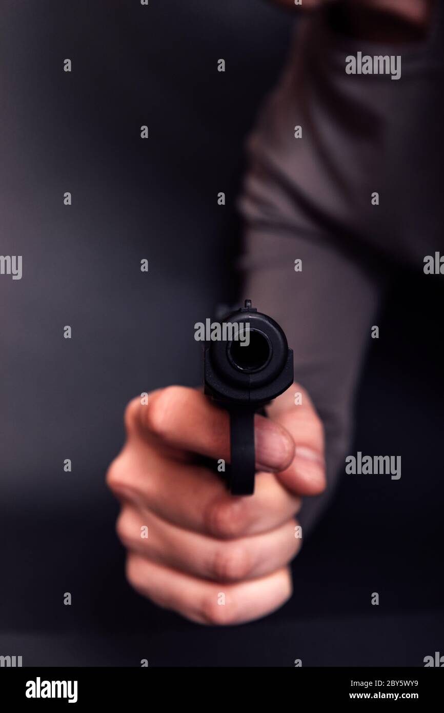 Male hand with gun isolated on black background. Man with a gun ready ...