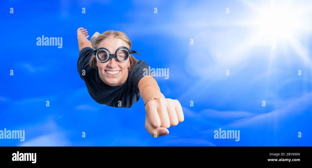 a concept image of a young strong woman flying with a clenched fist ...