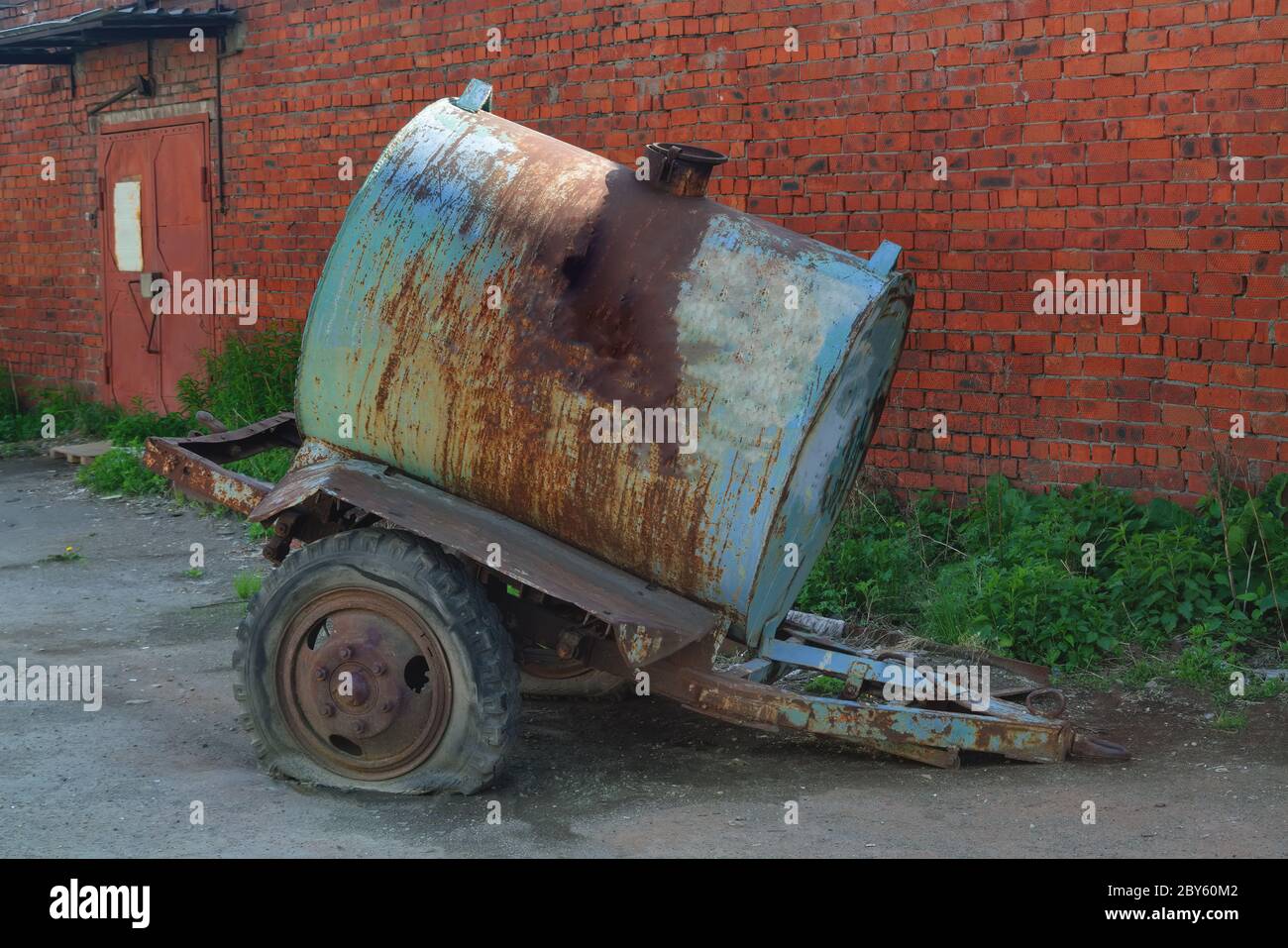 Old rusty tanker truck trailer on red brick wall background Stock Photo ...